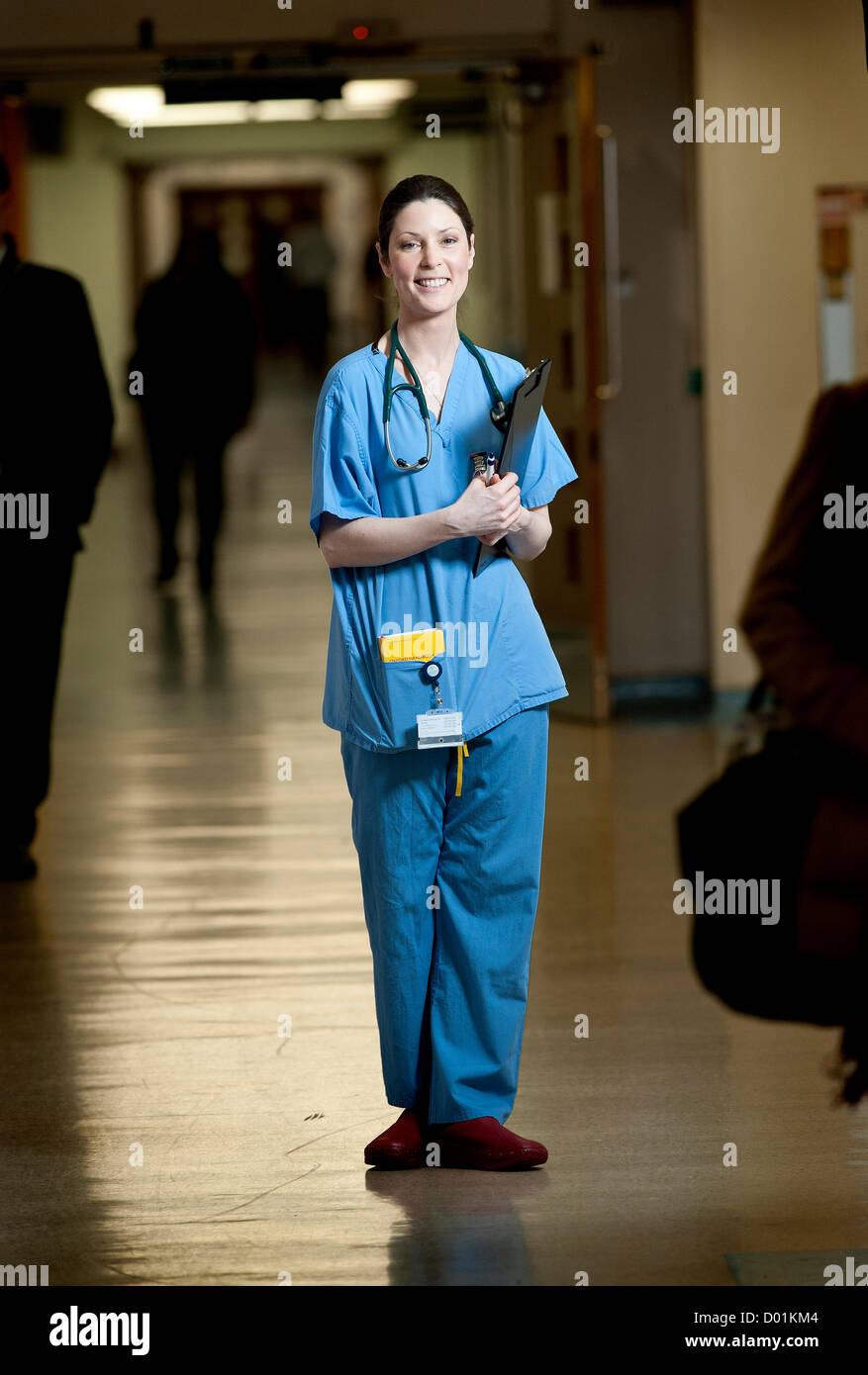 A trainee doctor poses in a busy hospital corridor Stock Photo - Alamy