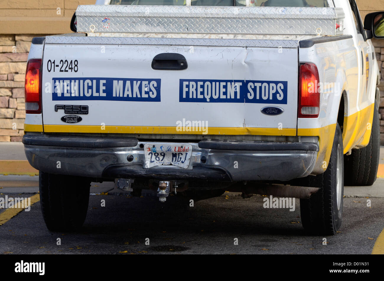 Dented truck with "Vehicle Makes Frequent Stops" sign Stock Photo - Alamy