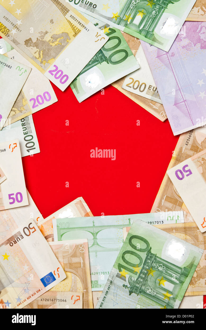 Euro bills on red background,recorded above them Stock Photo - Alamy