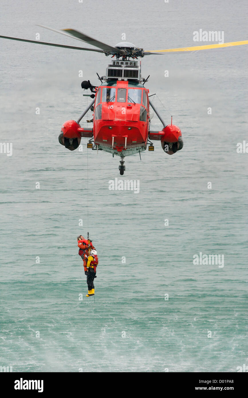 A winchman being lowered from a Search and Rescue helicopter off ...