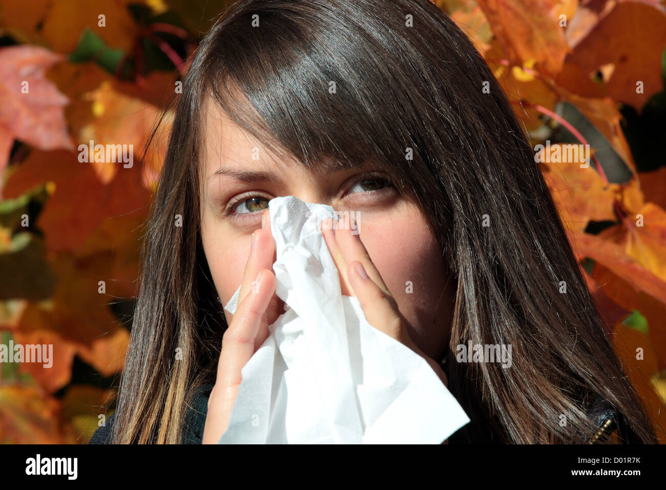 Teen Girl blowing her nose outdoors in late autumn Stock Photo - Alamy