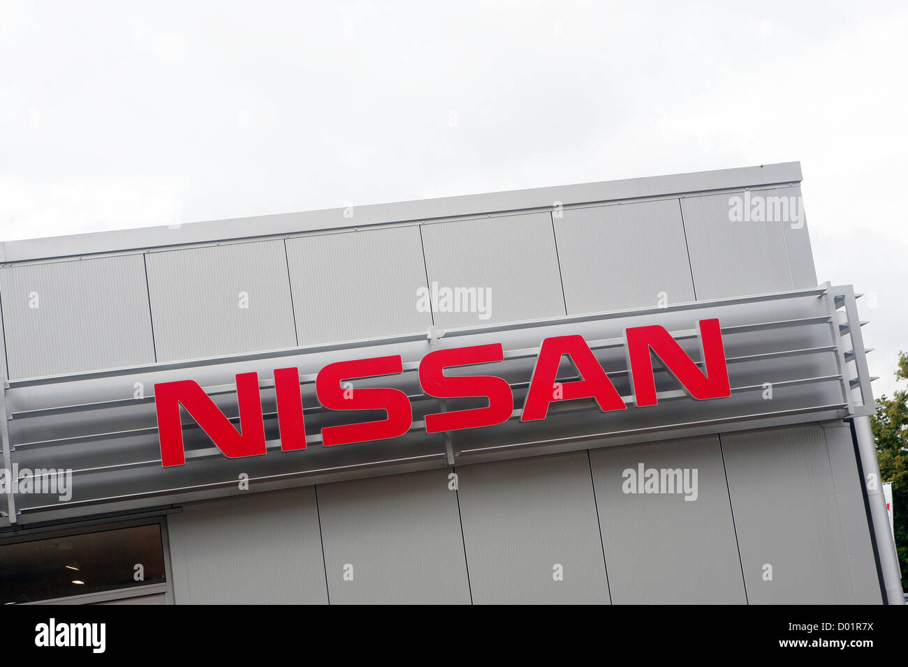 The exterior of a Nissan car dealership in the UK with a large Nissan ...