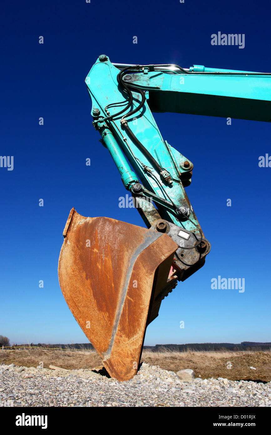 excavator on a building site on a sunny day Stock Photo - Alamy