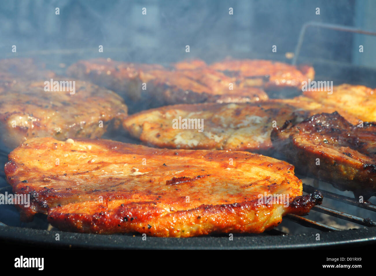 meat on the barbecue in summer showing food concept Stock Photo - Alamy