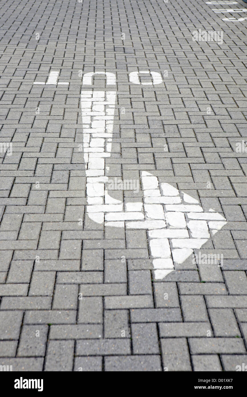 Road directions painted on the ground directing motorists out of car ...