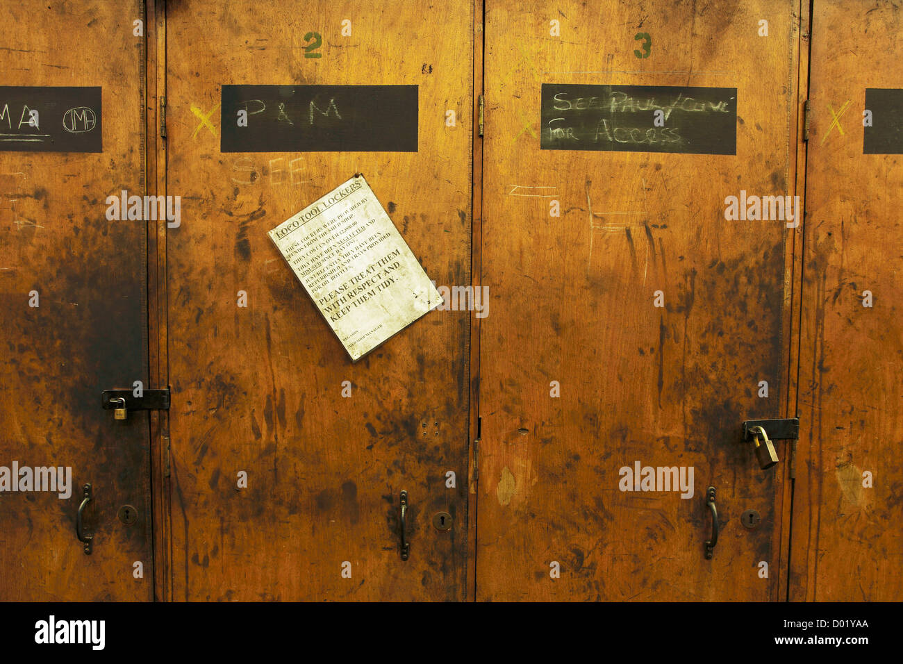 Some old worn out and abused wooden lockers with an amusing sign asking ...