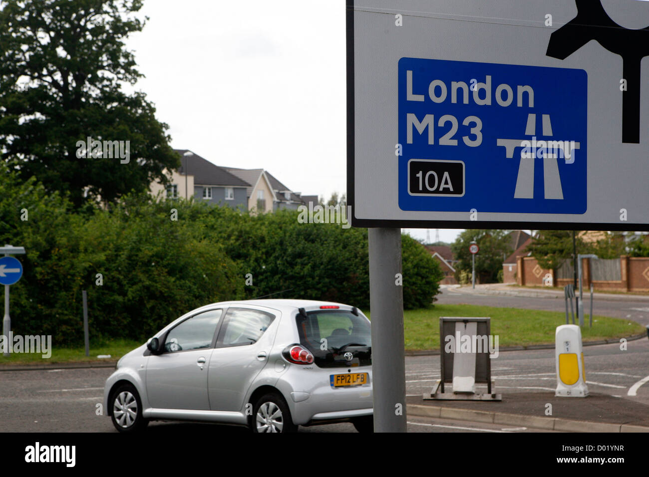 A motorway sign on a roundabout directing motorists to London M23 in ...