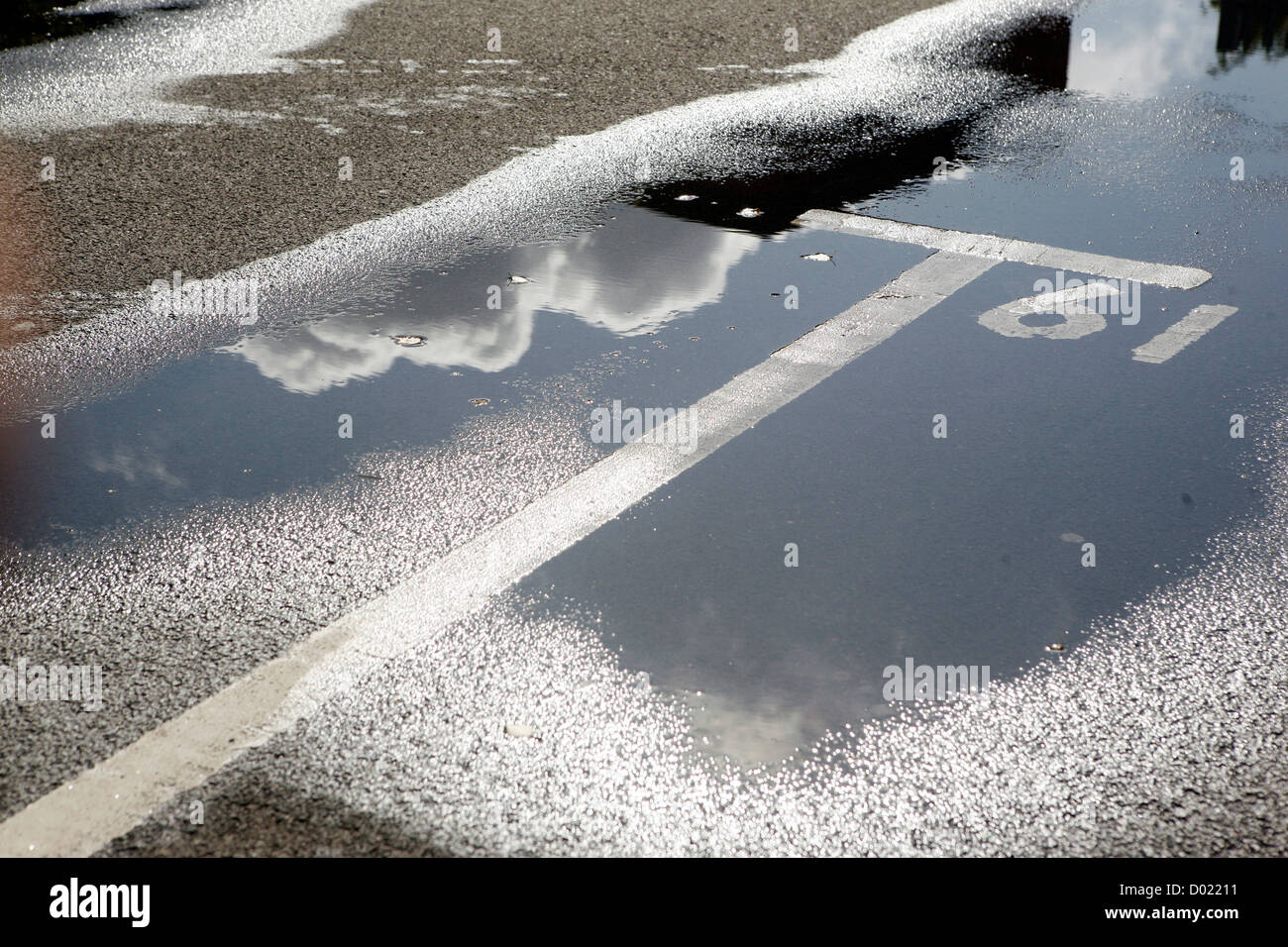 The reflection of the sky in a puddle at a car park Stock Photo - Alamy