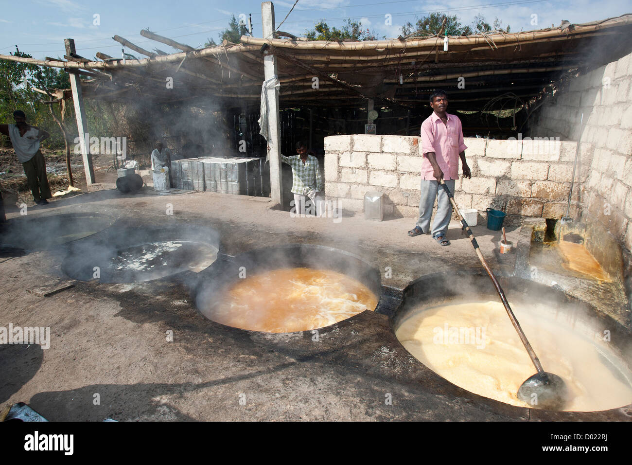 Boiling sugar cane juice to make unrefined jaggery or gur Gujarat India ...