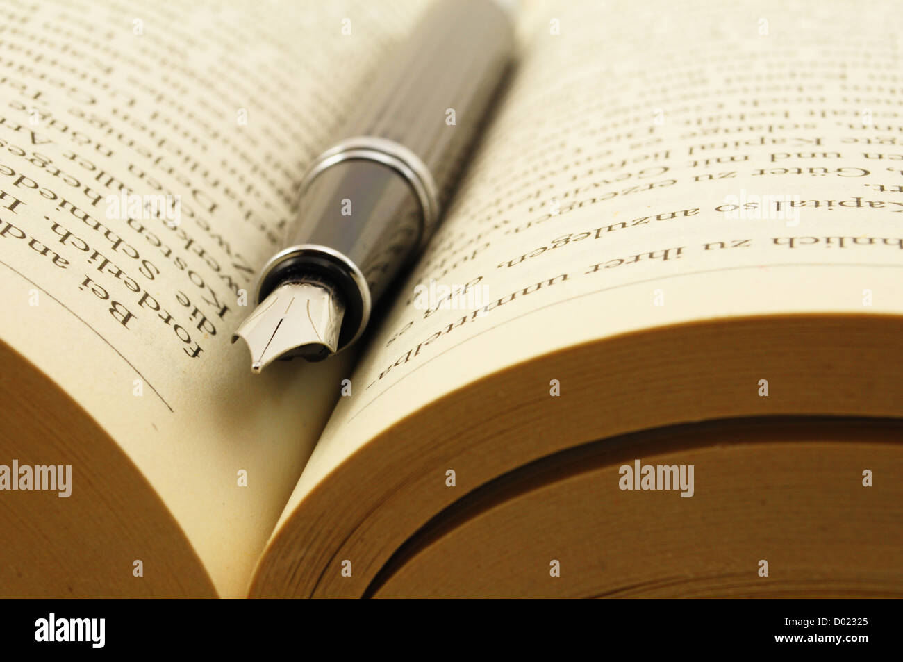 education or reading concept with book and pen Stock Photo - Alamy