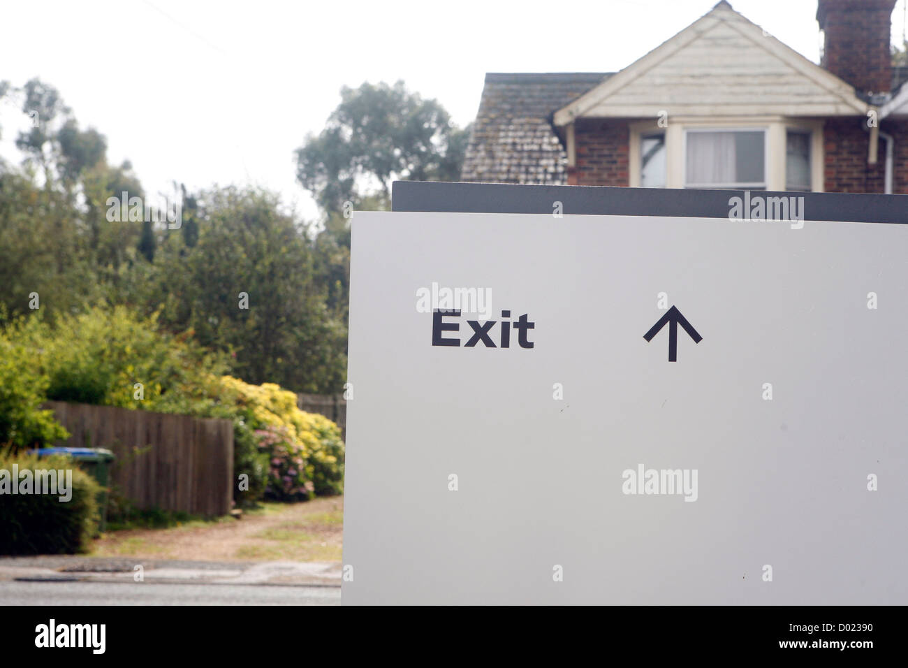 A grey display board with an arrow and exit sign Stock Photo - Alamy