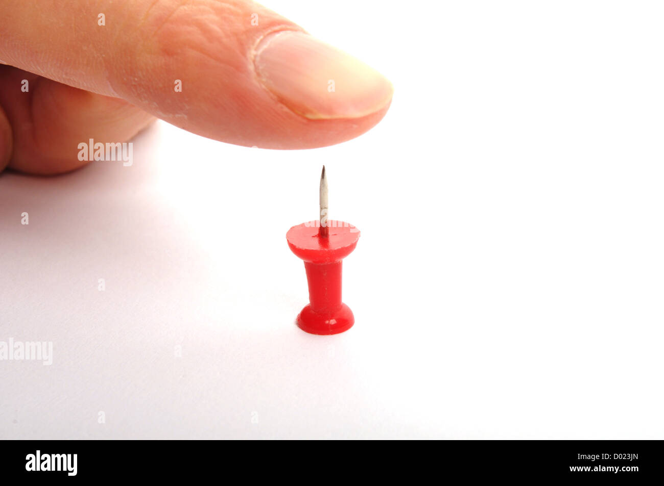 risk concept with finger over risky pin Stock Photo - Alamy