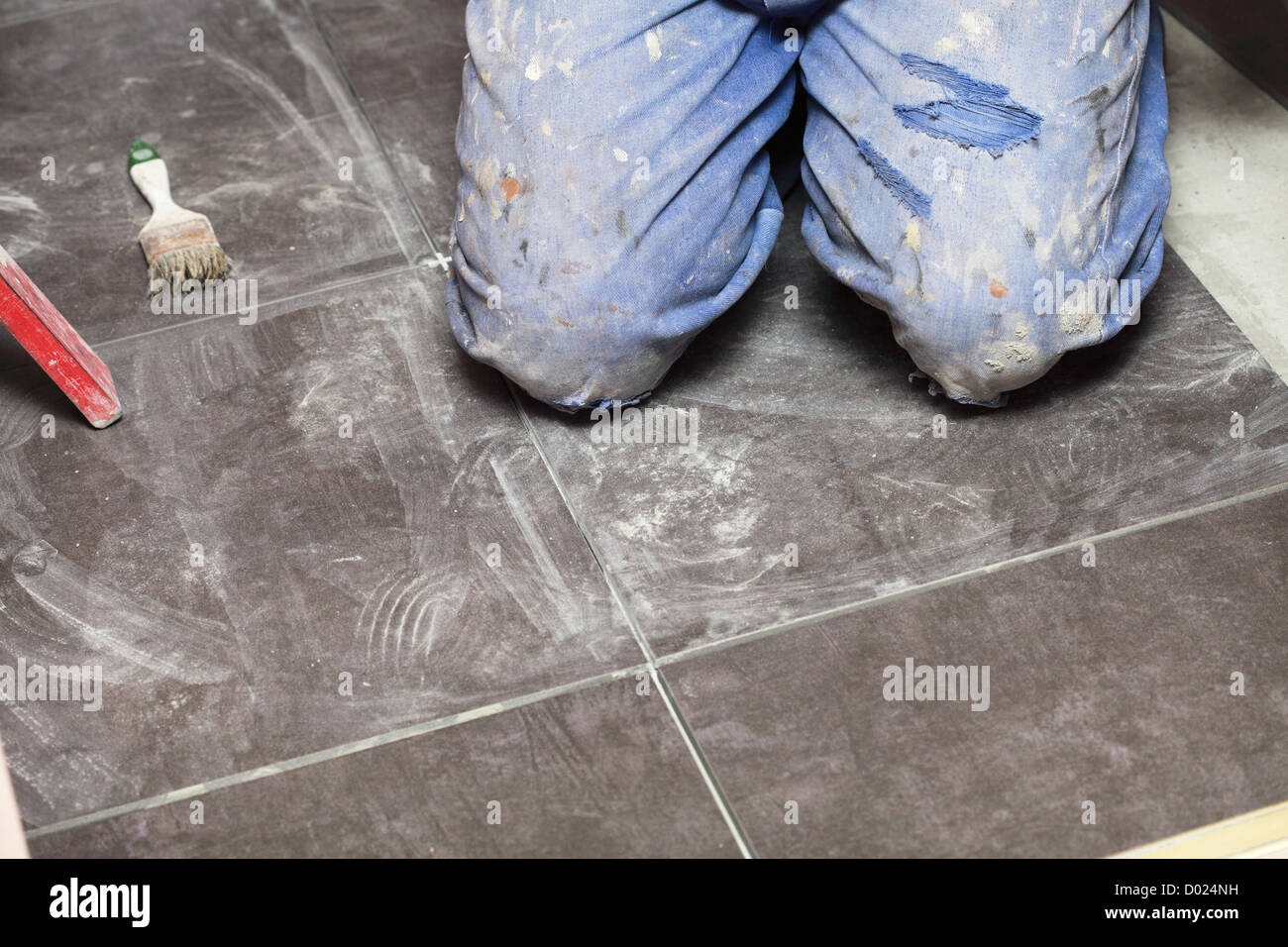 Man Construction worker is tiling at home, tile floor adhesive Stock ...