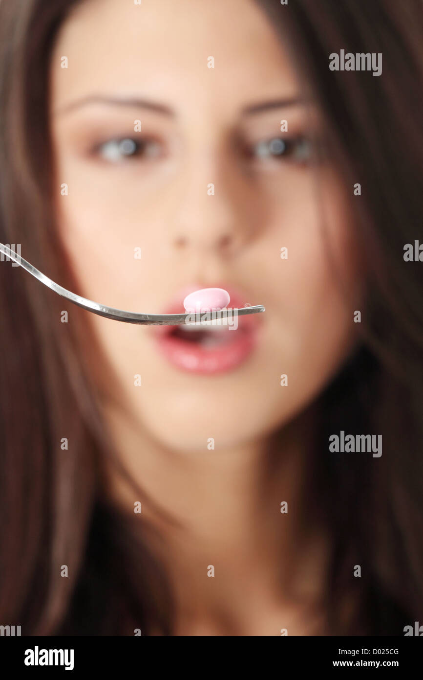 Woman eating nutritional supplement Stock Photo - Alamy