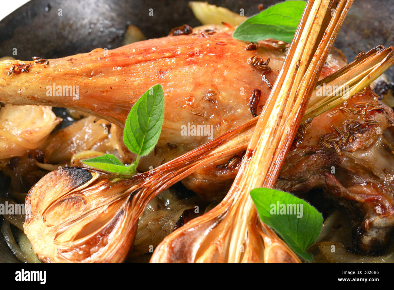 Roast duck leg with sauteed onion Stock Photo - Alamy