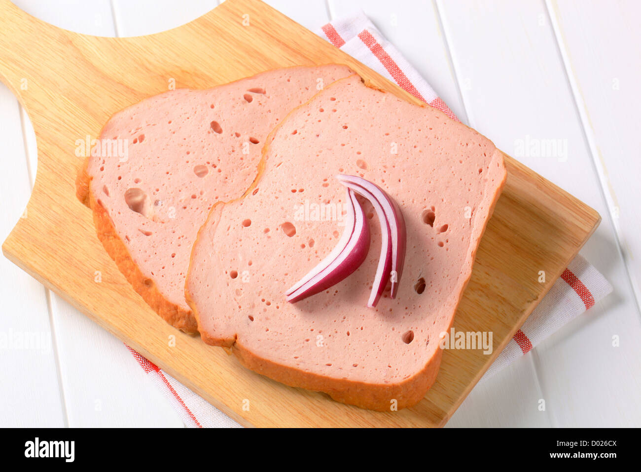 Slices of cold luncheon meat on cutting board Stock Photo - Alamy