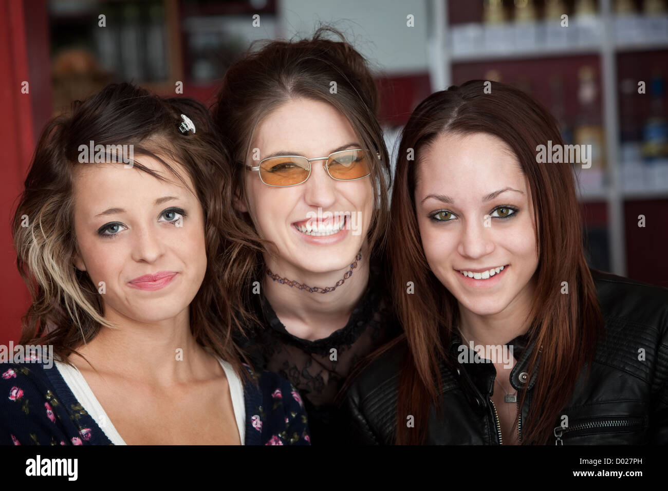 Three young cute teen friends smiling in a cafe Stock Photo - Alamy