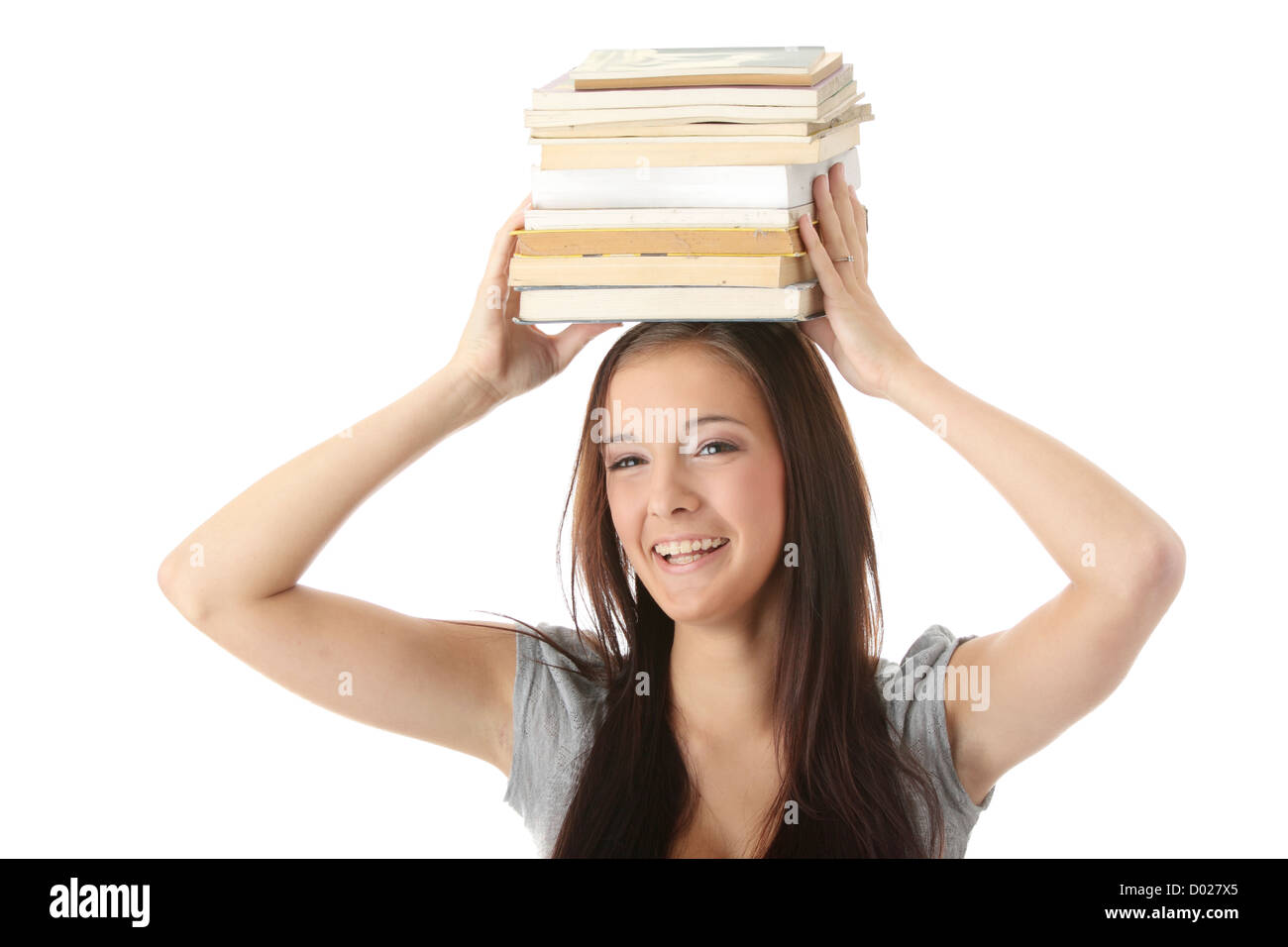 Teenage girl struggling with stack of books isolated Stock Photo - Alamy
