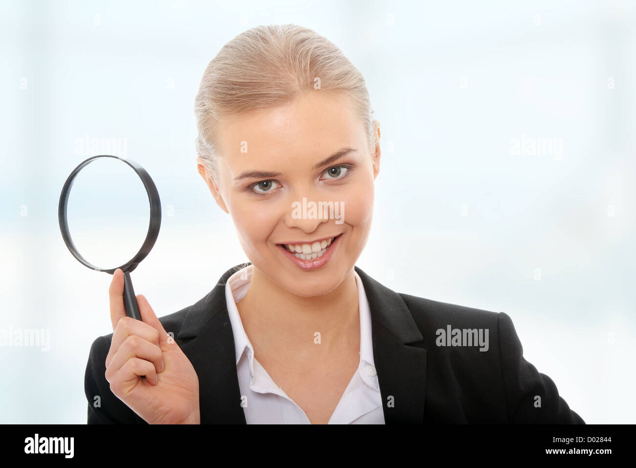 Business woman looking into a magnifying glass Stock Photo - Alamy