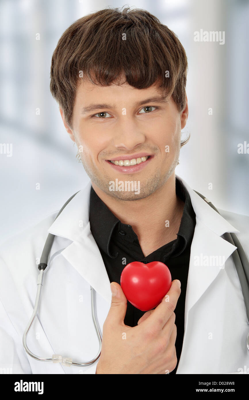 Doctor holding heart shape toy Stock Photo - Alamy