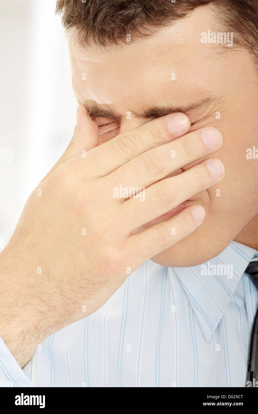 Businessman with a big headache Stock Photo - Alamy