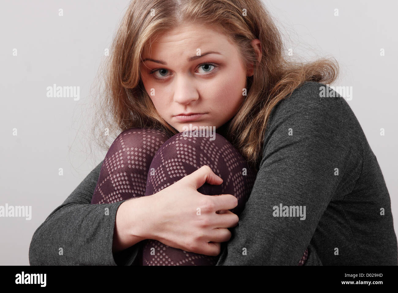 Sad or depressed woman sitting on the flor Stock Photo - Alamy