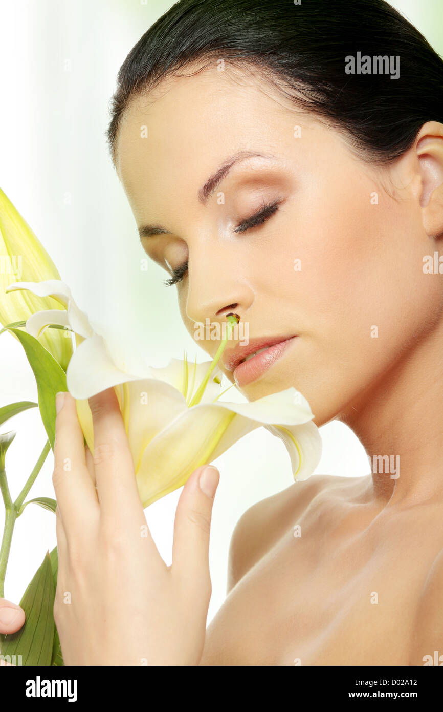 Beautiful young woman face with perfect skin with lily flower Stock ...