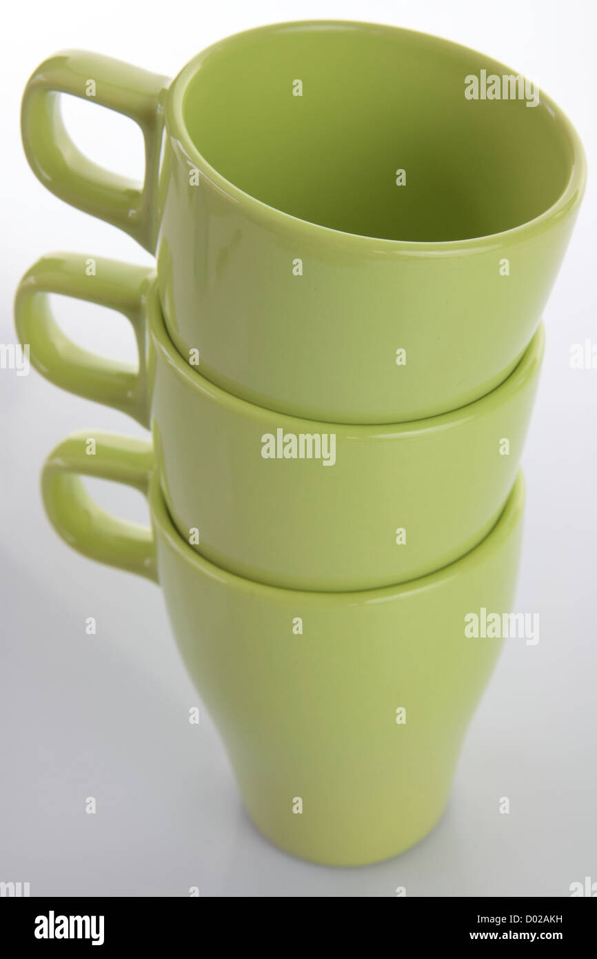 Three empty green mugs isolated Stock Photo - Alamy