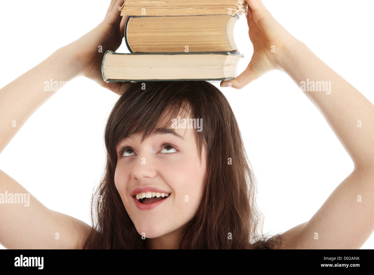 Teen student girl with lot of heavy books isolated on white background ...