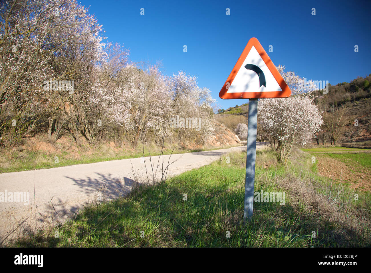 danger curve at a rural road in Spain Stock Photo - Alamy