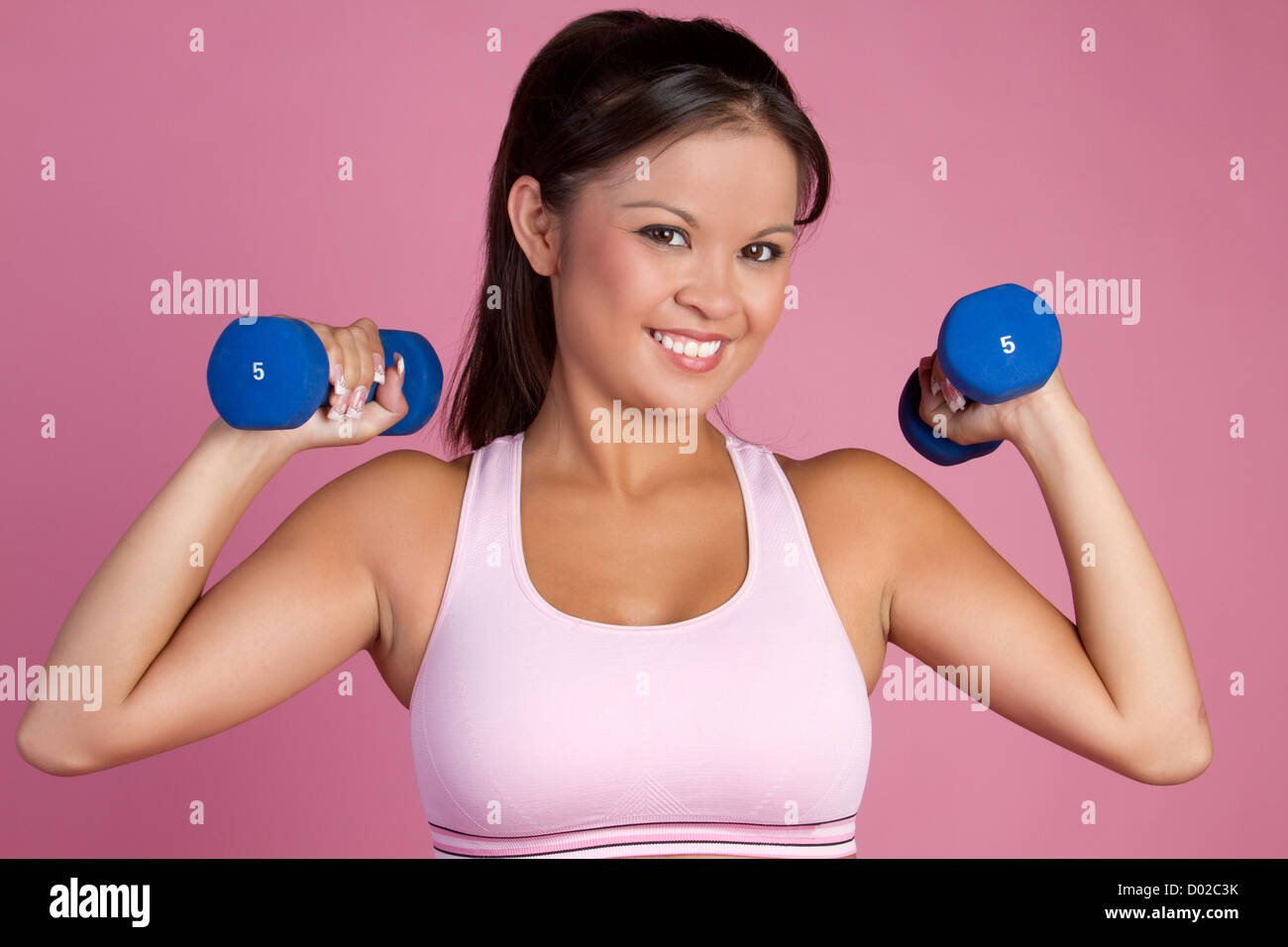 Smiling asian woman lifting weights Stock Photo - Alamy