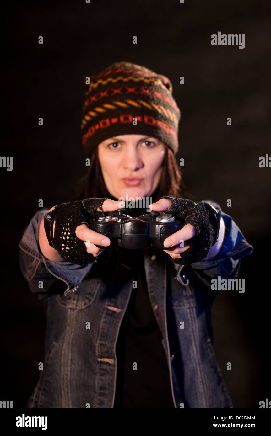 woman gamer with joystick on dark background Stock Photo - Alamy