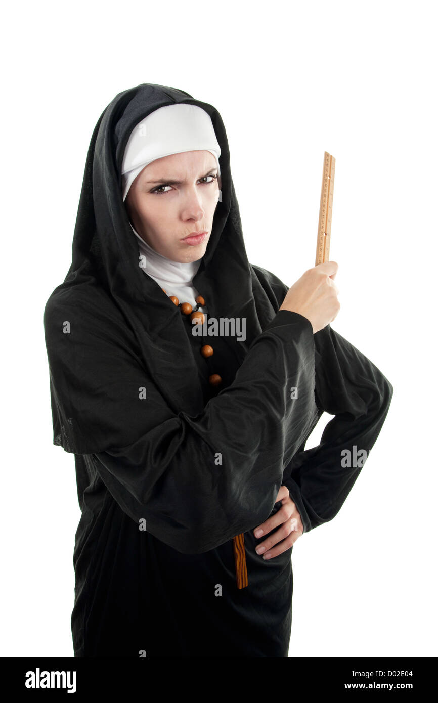 Young, angry Catholic nun lwith ruler in hand on a white background ...