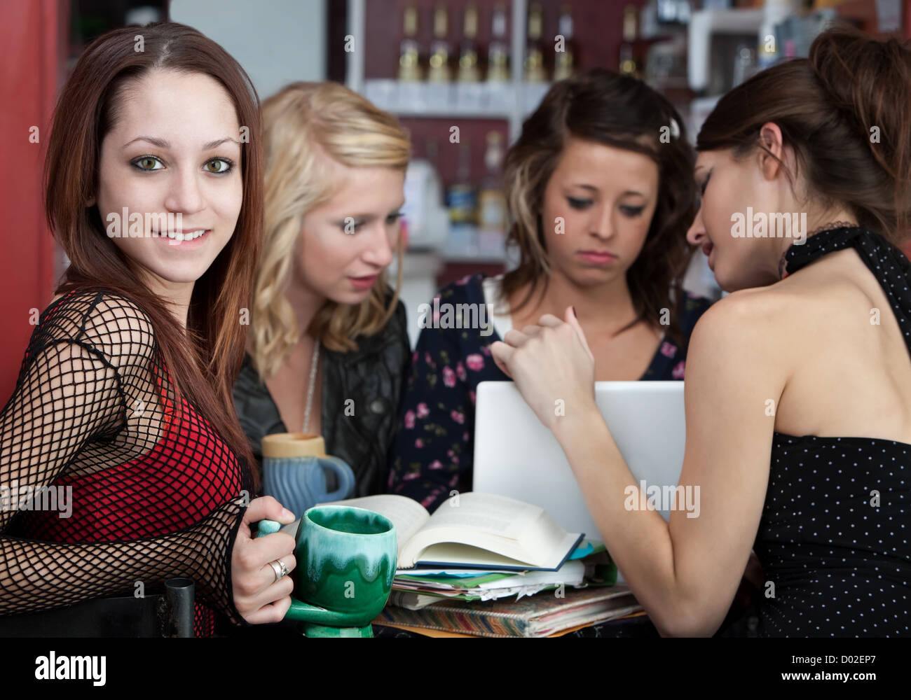Good looking teenaged girl doing homework with friends Stock Photo - Alamy