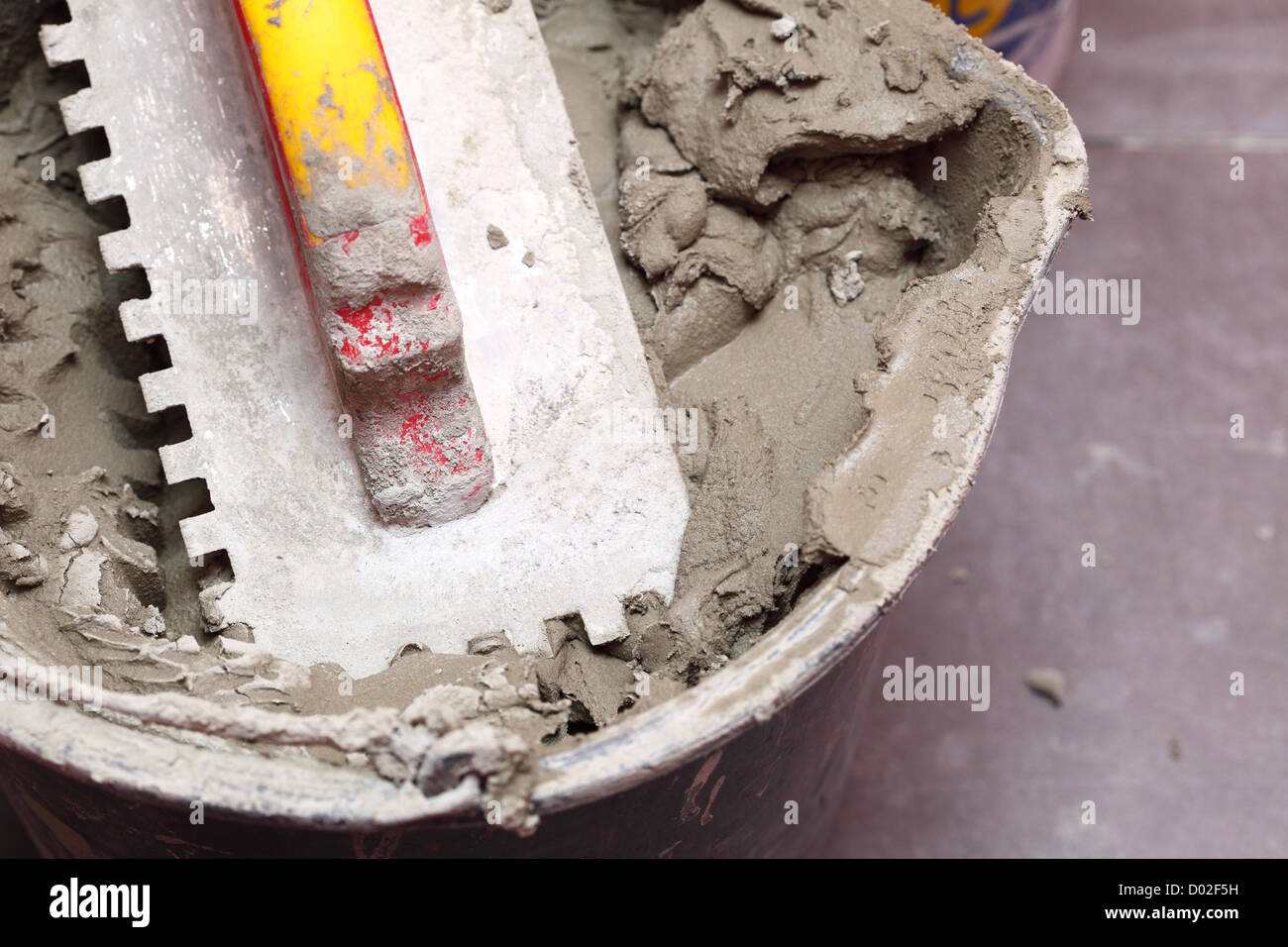mortar on wall construction notched trowel work tools Stock Photo - Alamy