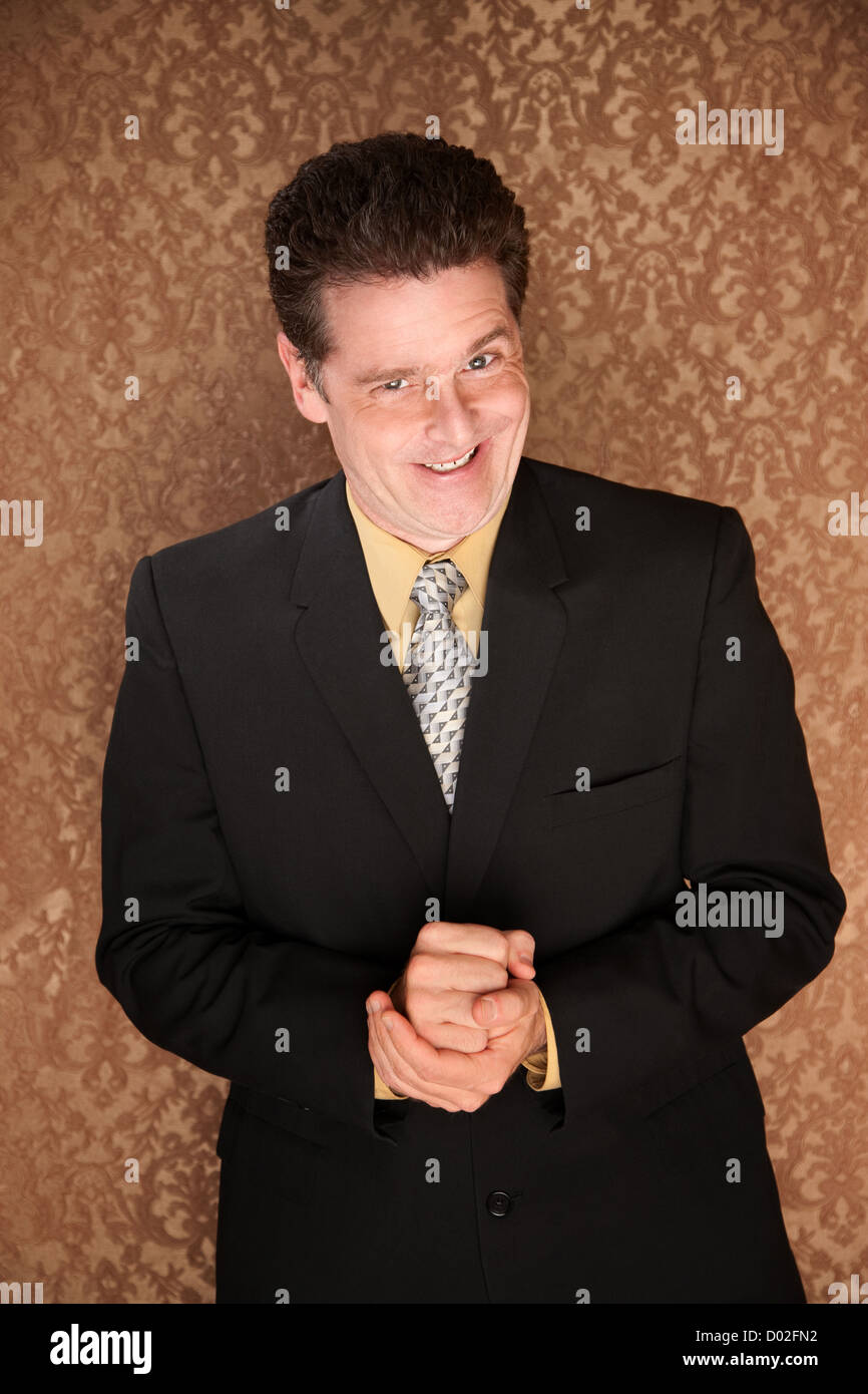 Young Caucasian businessman wearing a sly smile Stock Photo - Alamy
