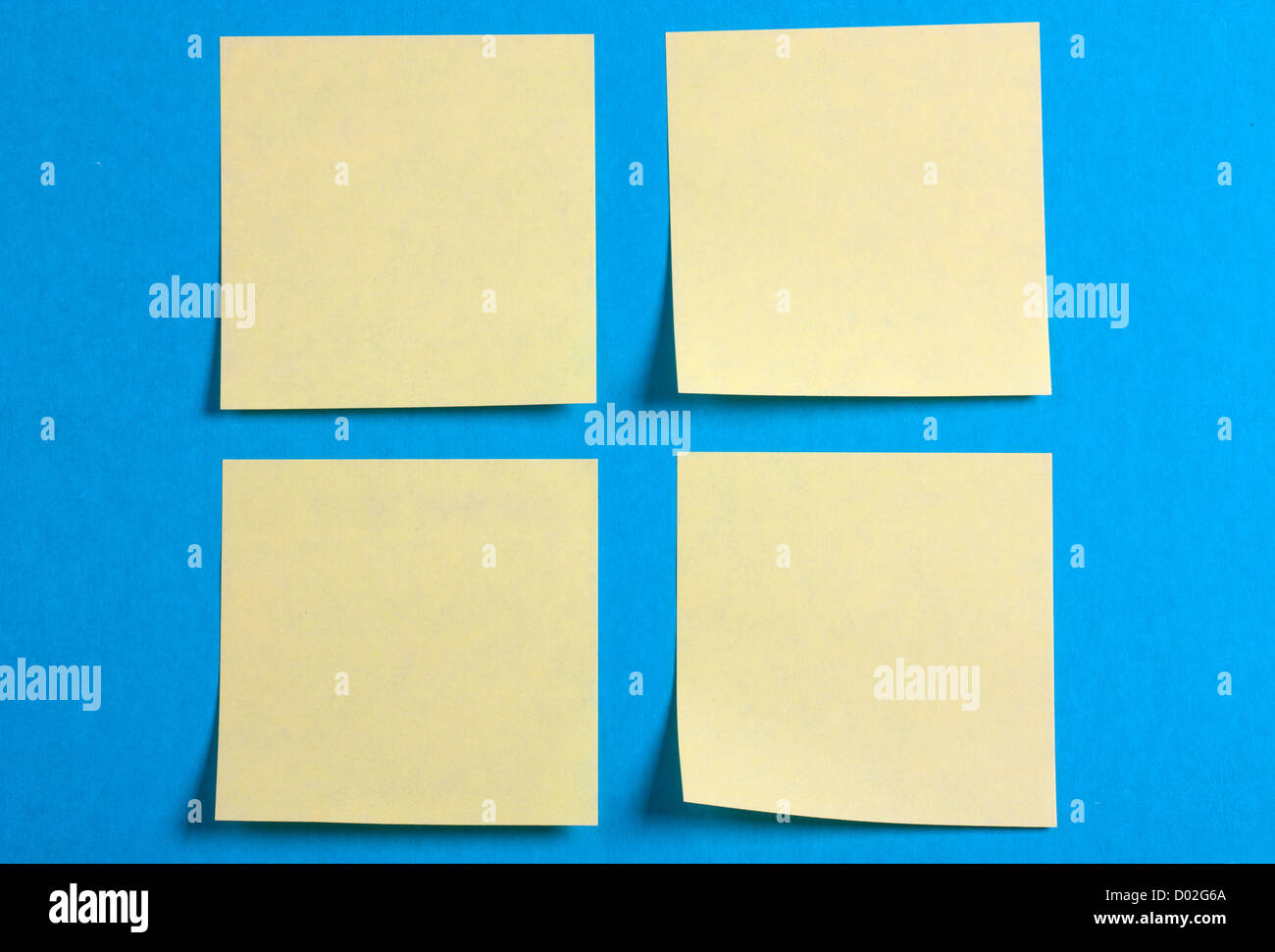 Yellow notes on a blue background Stock Photo - Alamy