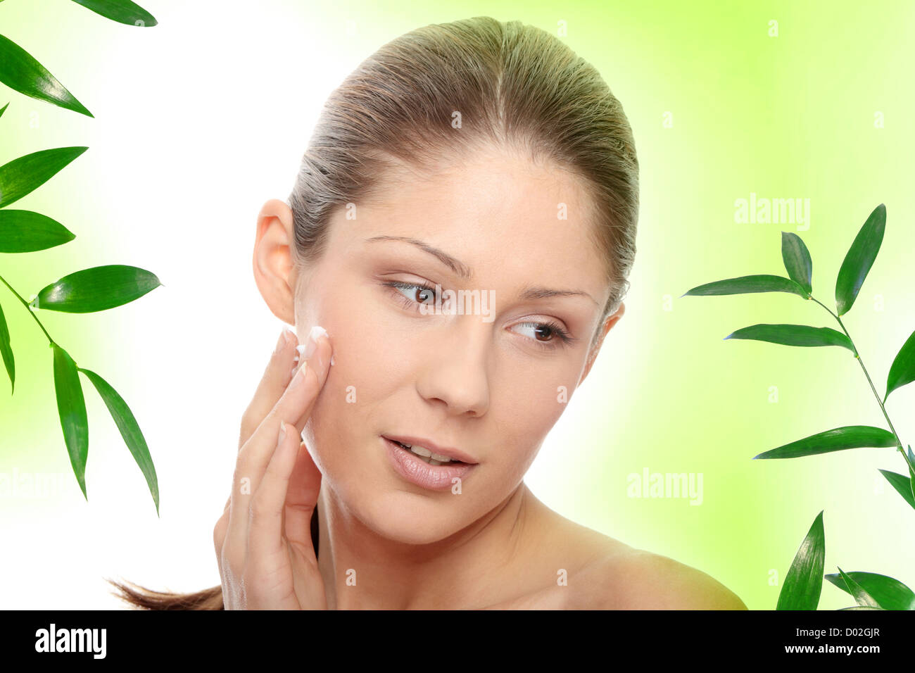 Beautiful young woman with cream Stock Photo - Alamy