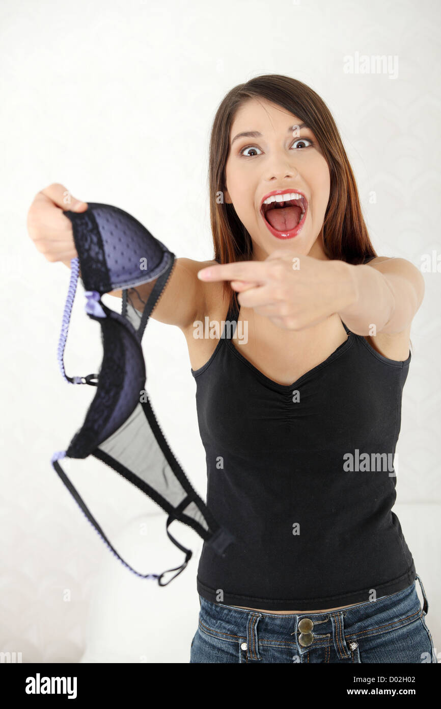 Angry woman with bra in hand Stock Photo - Alamy