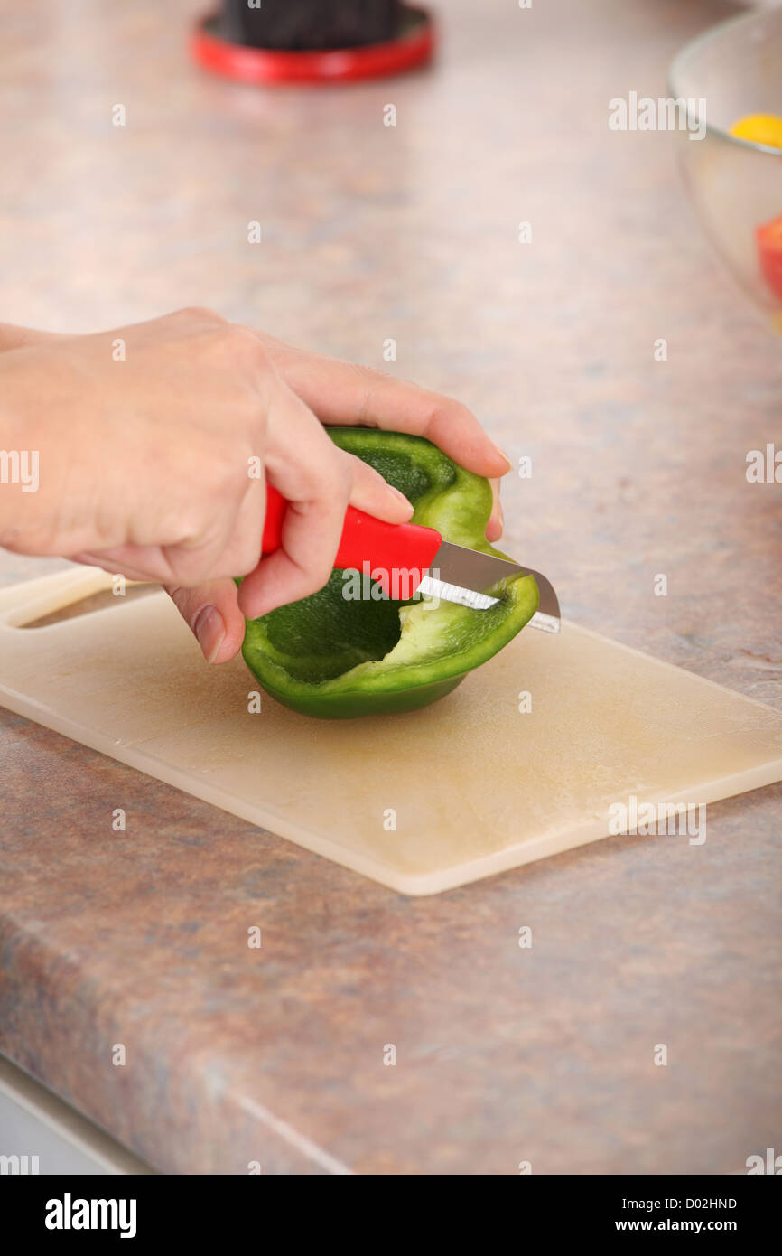 Chopping bright yellow pepper knife hi-res stock photography and images ...