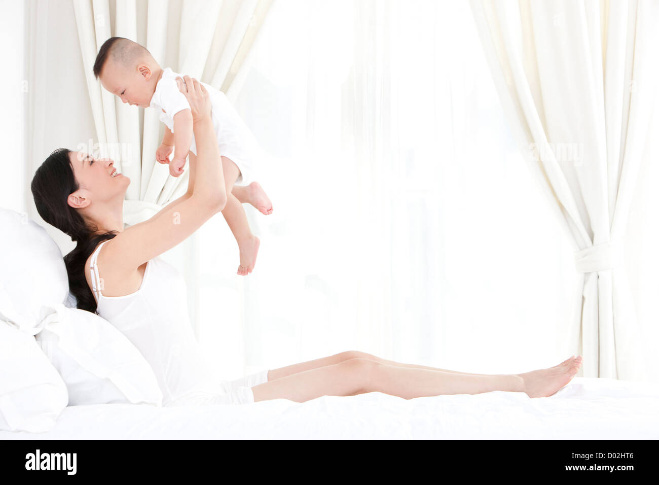 Mother loving cute little baby Stock Photo - Alamy