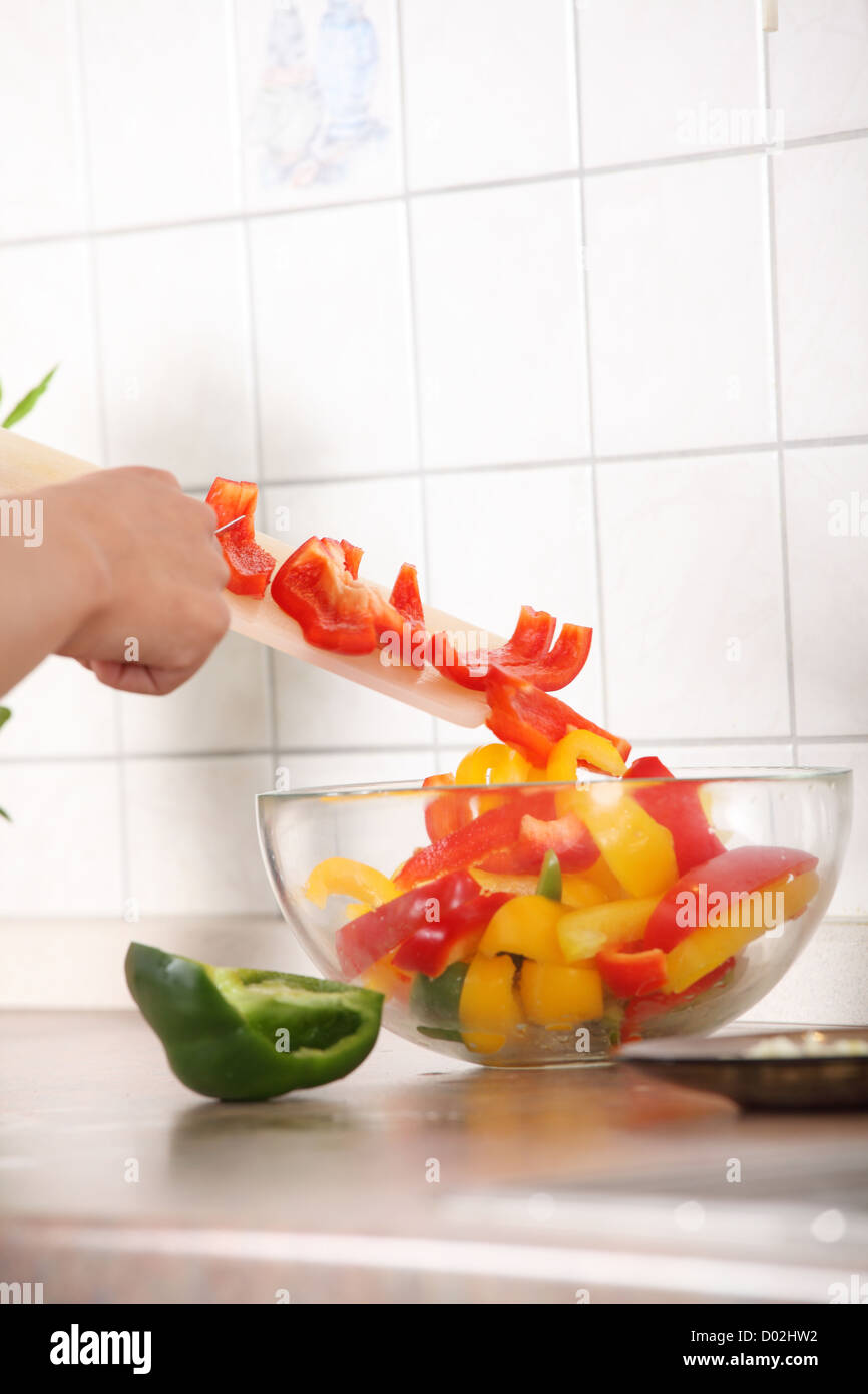 Female chopping food ingredients (paprika) on the kitchen Stock Photo ...
