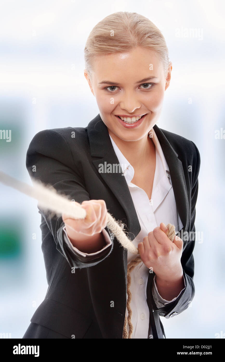 Businesswoman pulling on a piece of rope. Isolated on white Stock Photo ...