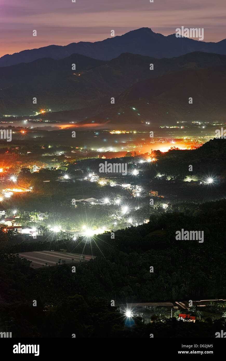 Rural night scene with mist over hill and buildings Stock Photo - Alamy