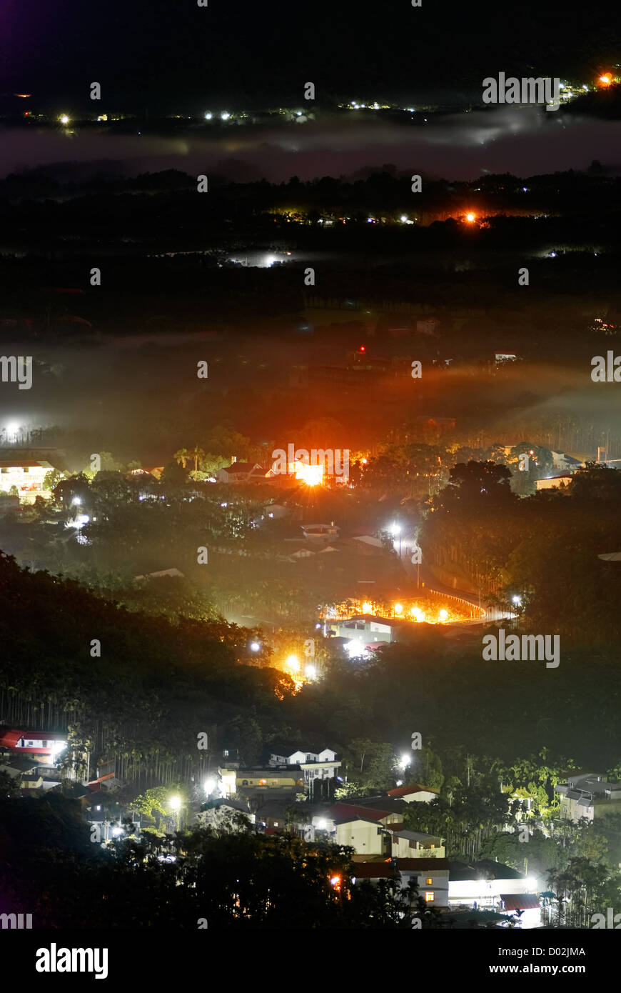 Colorful rural night scenery with light in town Stock Photo - Alamy