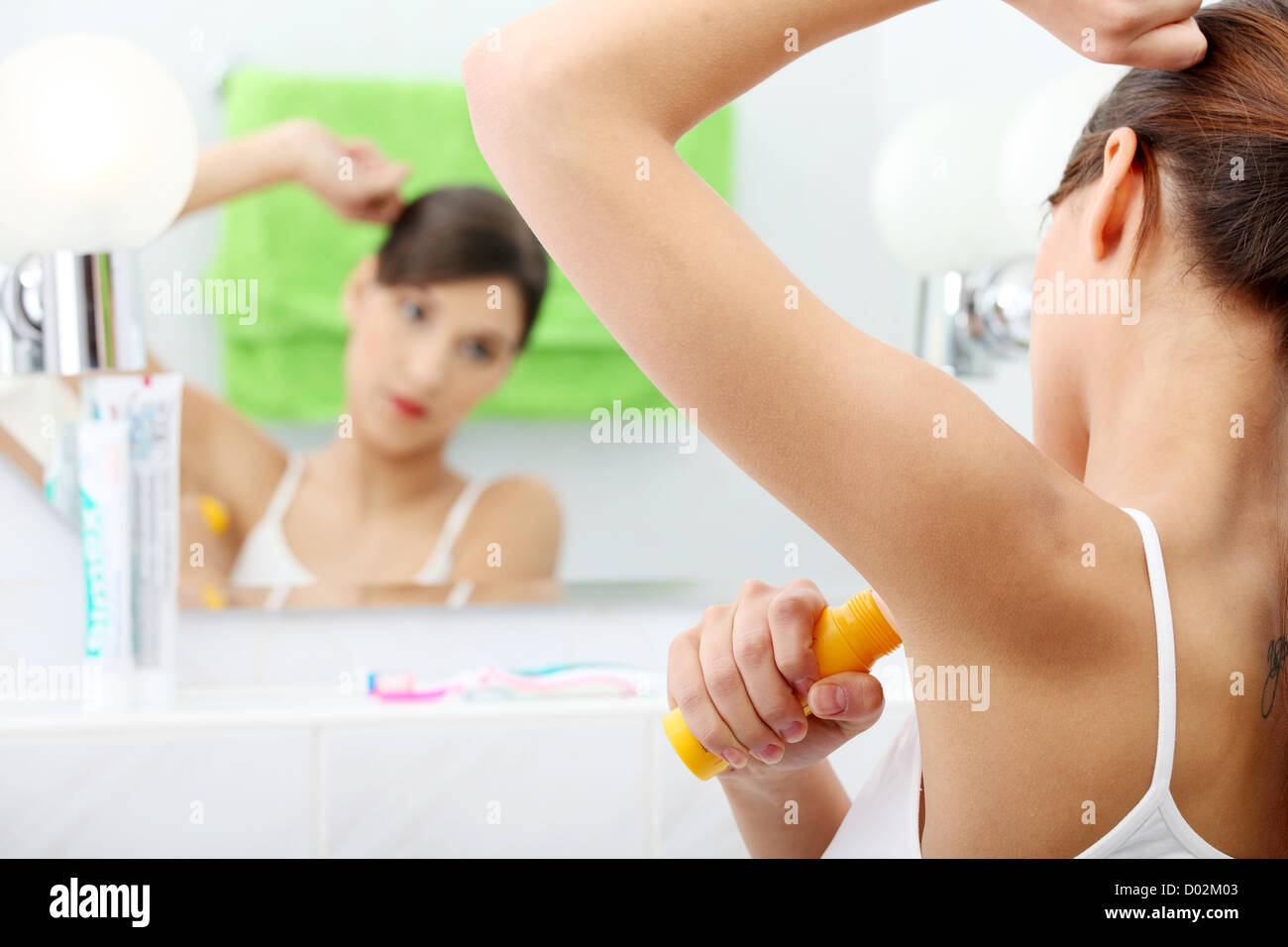 Young beautiful caucasian woman using deodorant Stock Photo - Alamy