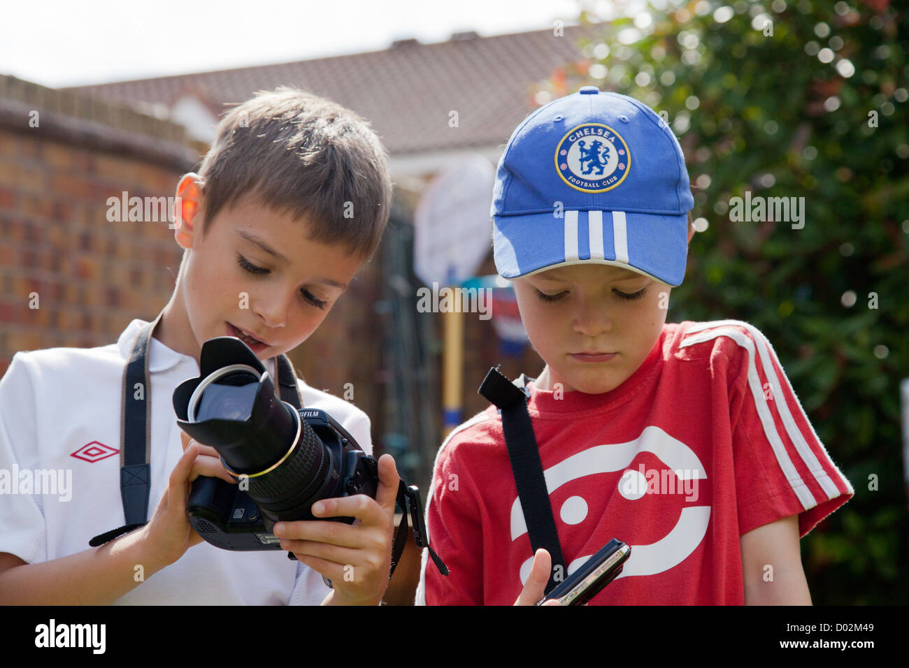 Young boys using cameras taking photographs Stock Photo - Alamy