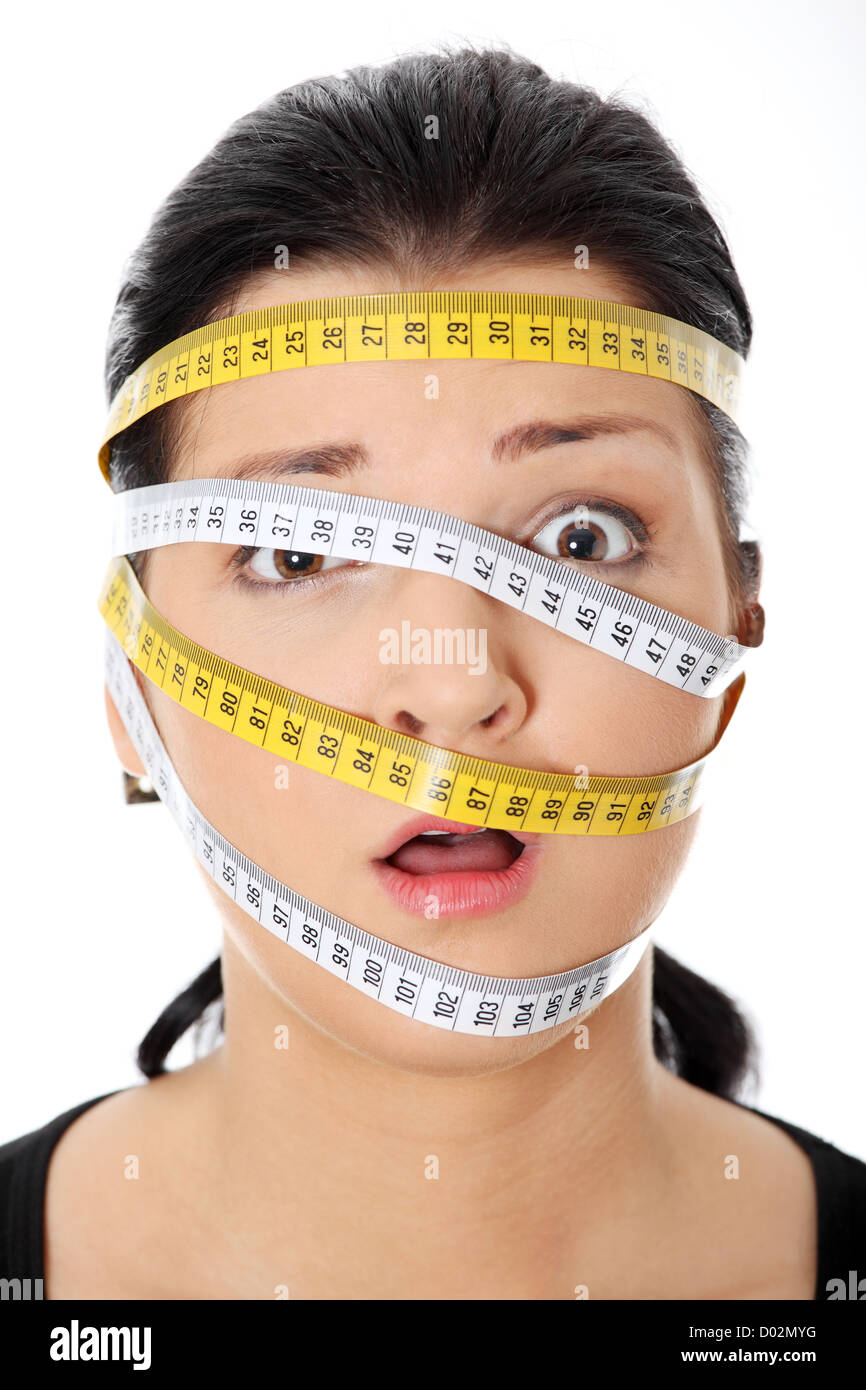 Woman with measuring tape around her head Stock Photo - Alamy