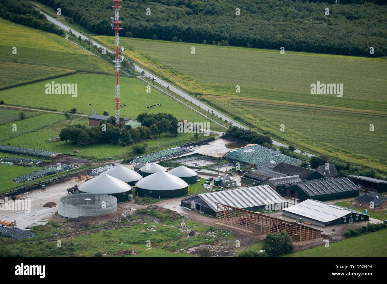 GERMANY aerial view of biogas plant and solar roofs on stable at farm ...