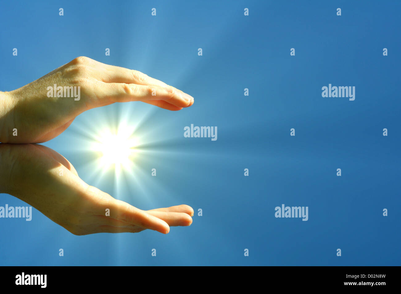 hand sun and blue sky with copyspace showing freedom or solar power ...